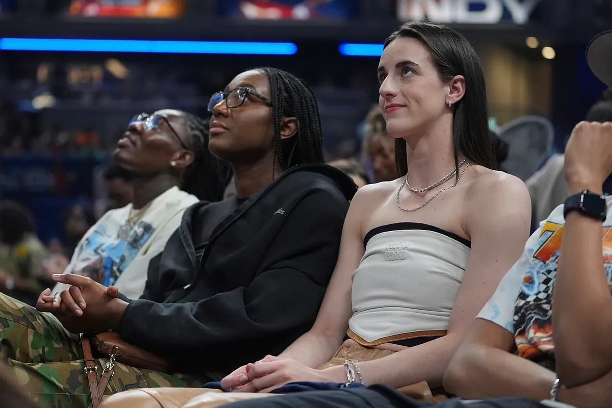 Caitlin Clark is coy as she tries to dodge a kiss from boyfriend Connor ...